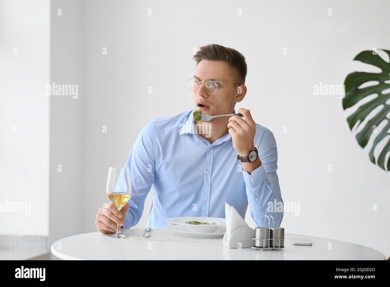 Young man eating tasty ravioli in cafe Stock Photo - Alamy