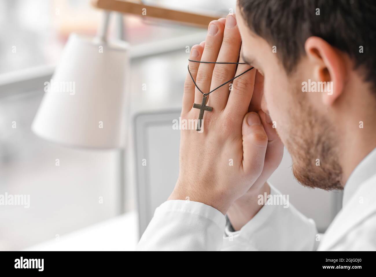 Religious doctor praying in clinic Stock Photo - Alamy