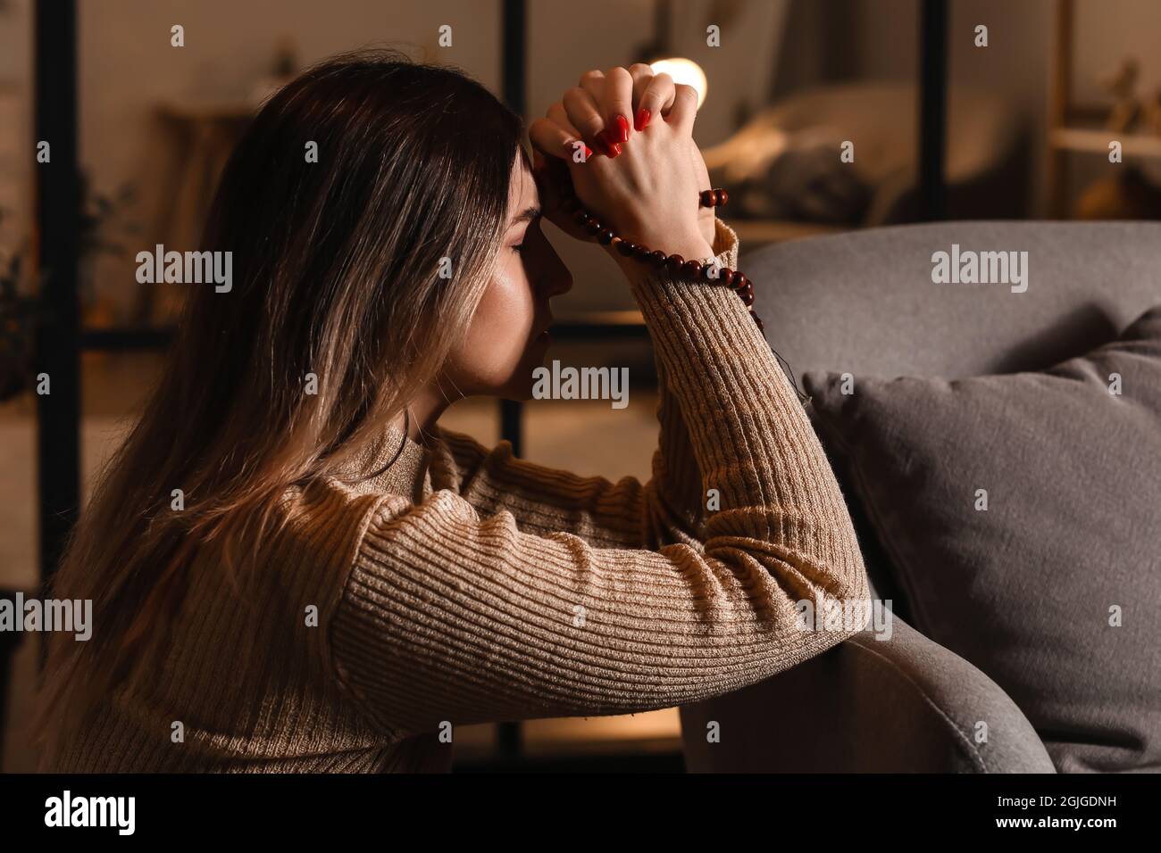 Praying woman in dark room hi-res stock photography and images - Alamy