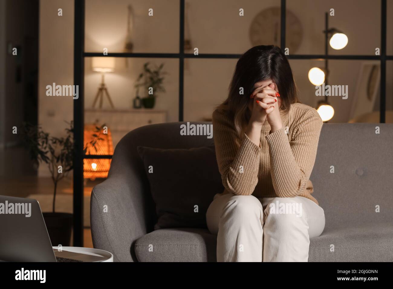 Religious young woman praying to God at home in evening Stock Photo - Alamy