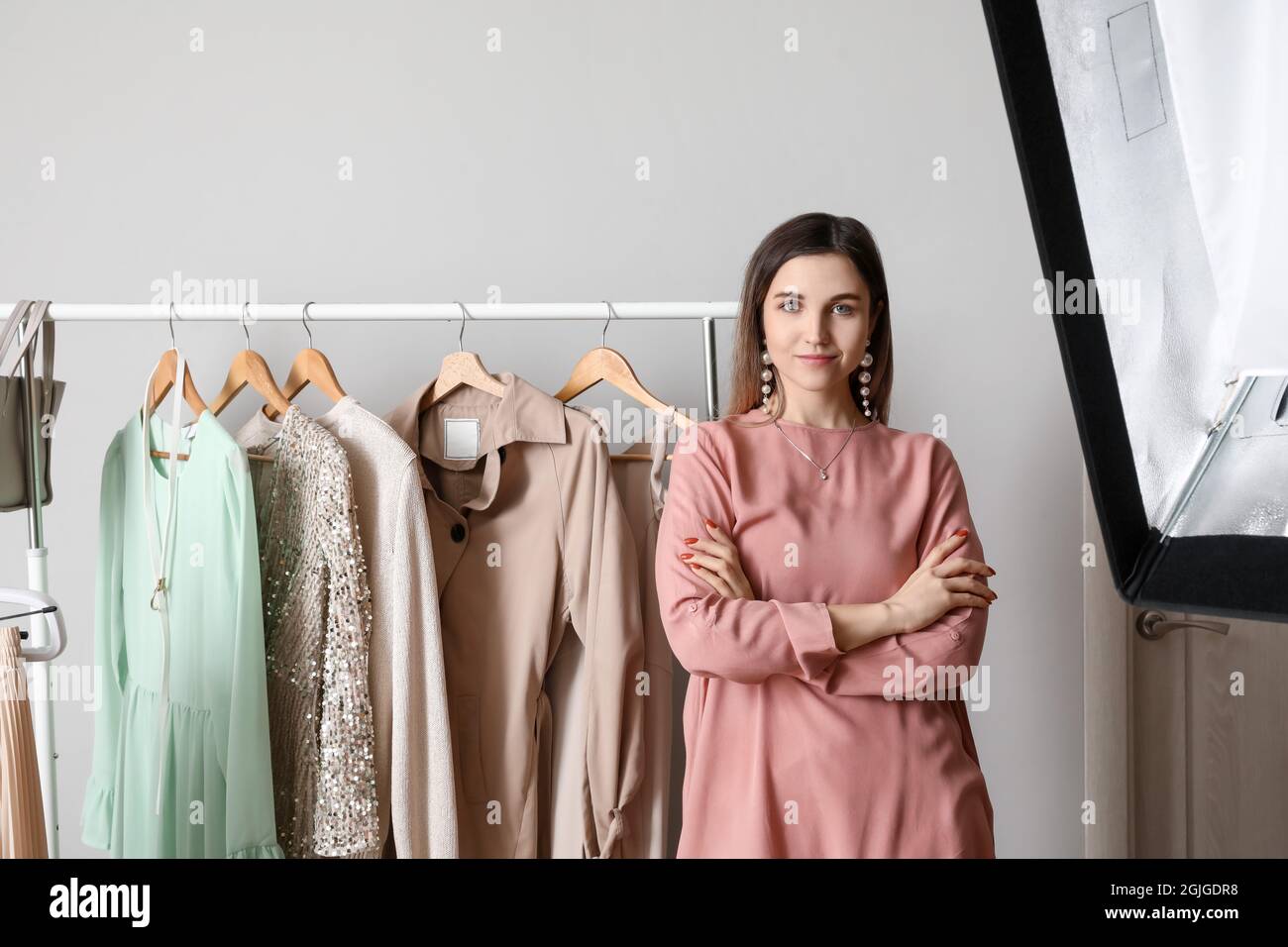 Female clothes stylist in photo studio Stock Photo - Alamy