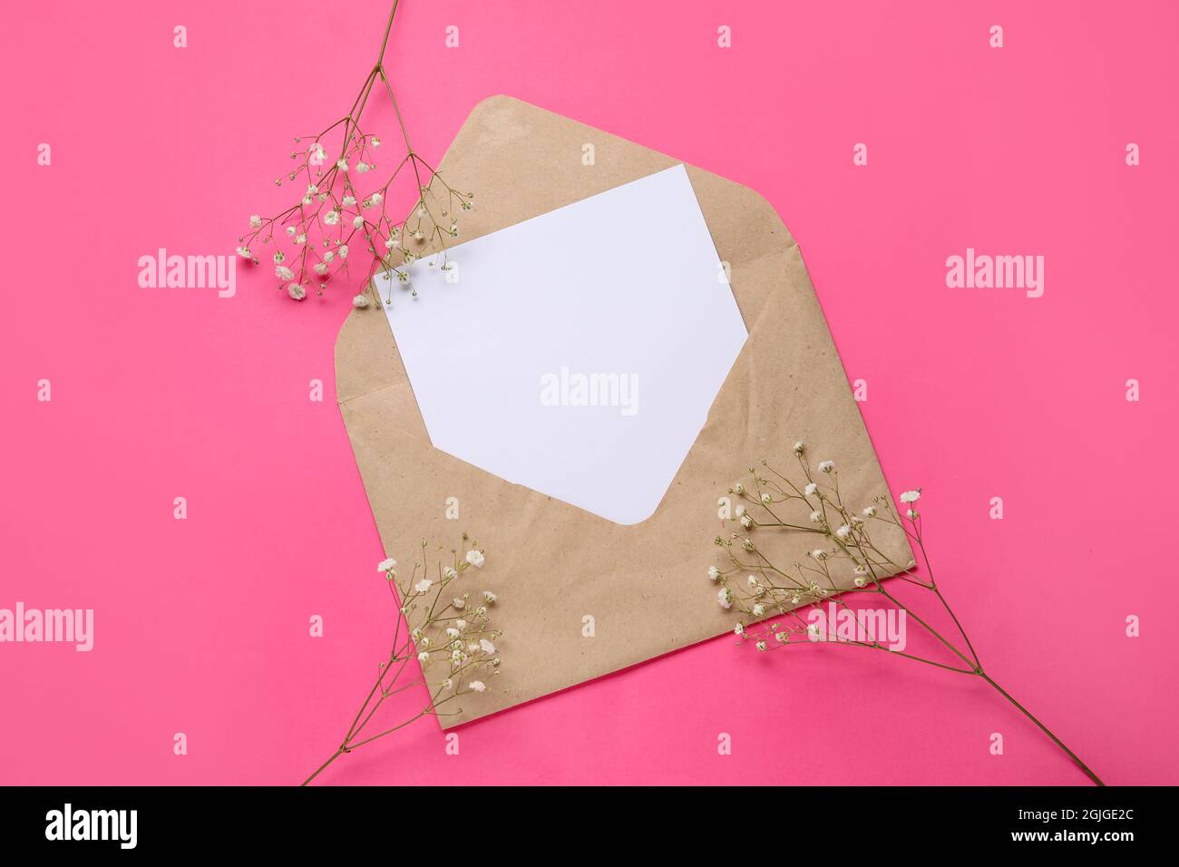 Envelope with blank card and flowers on color background Stock Photo ...