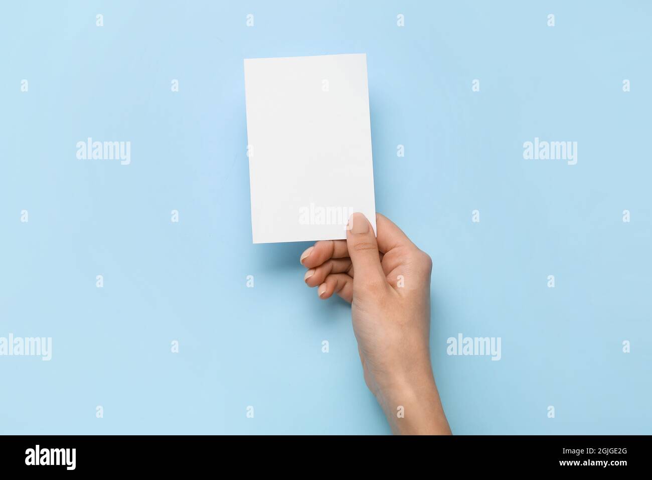 Female hand with blank card on color background Stock Photo - Alamy