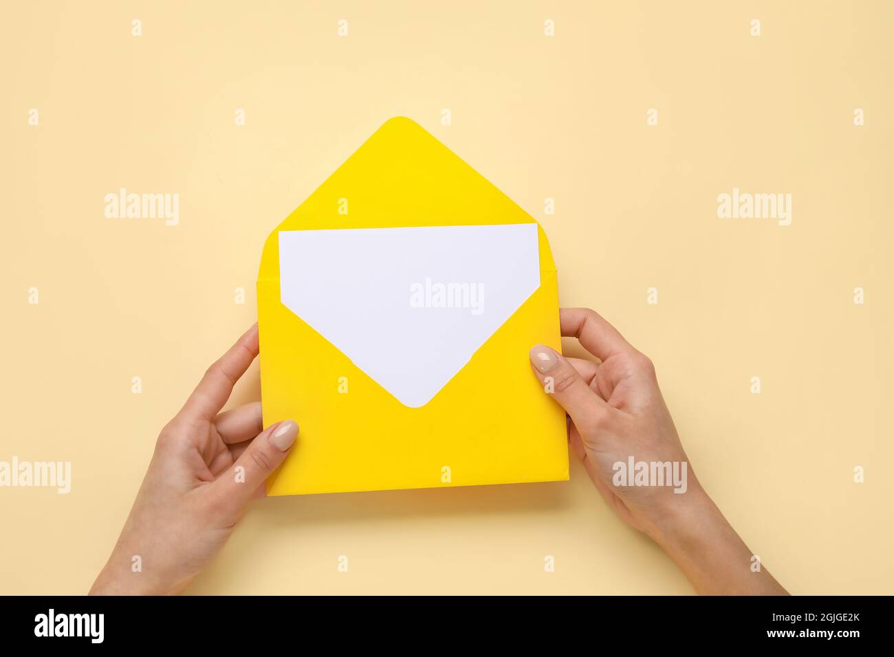 Female hands with envelope and blank card on color background Stock ...