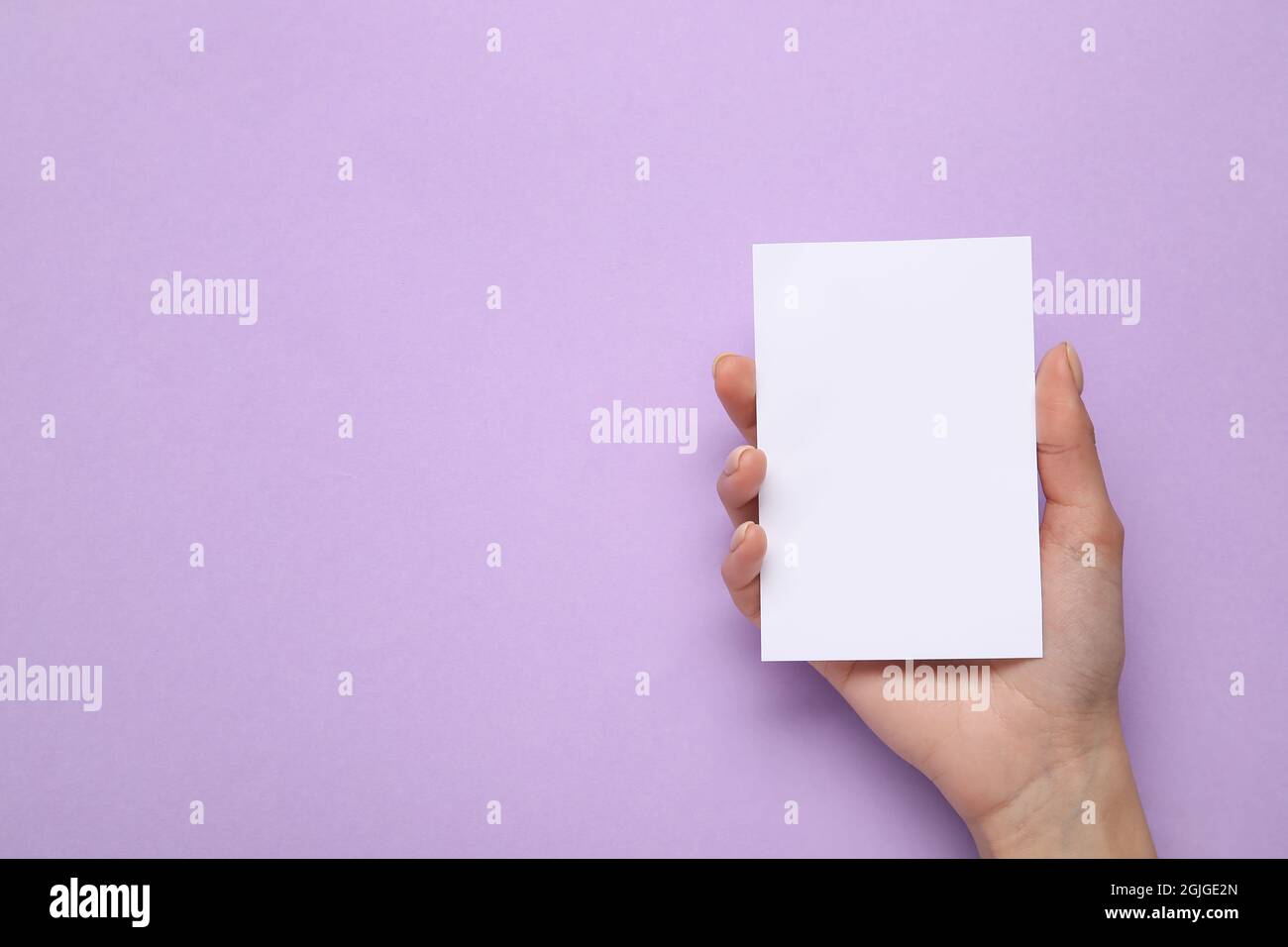 Female hand with blank card on color background Stock Photo - Alamy