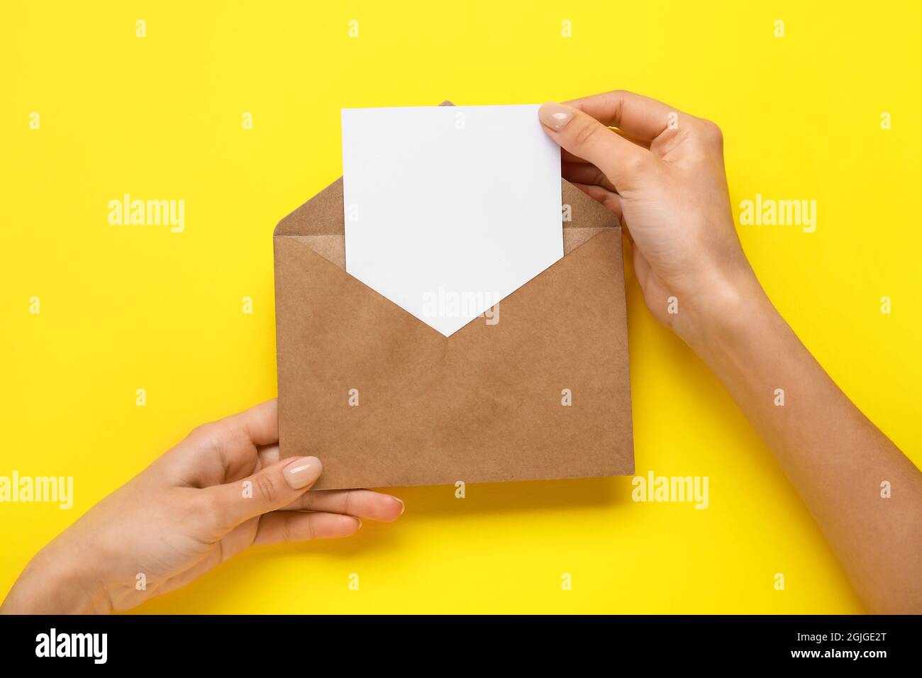 Female hands with envelope and blank card on color background Stock ...