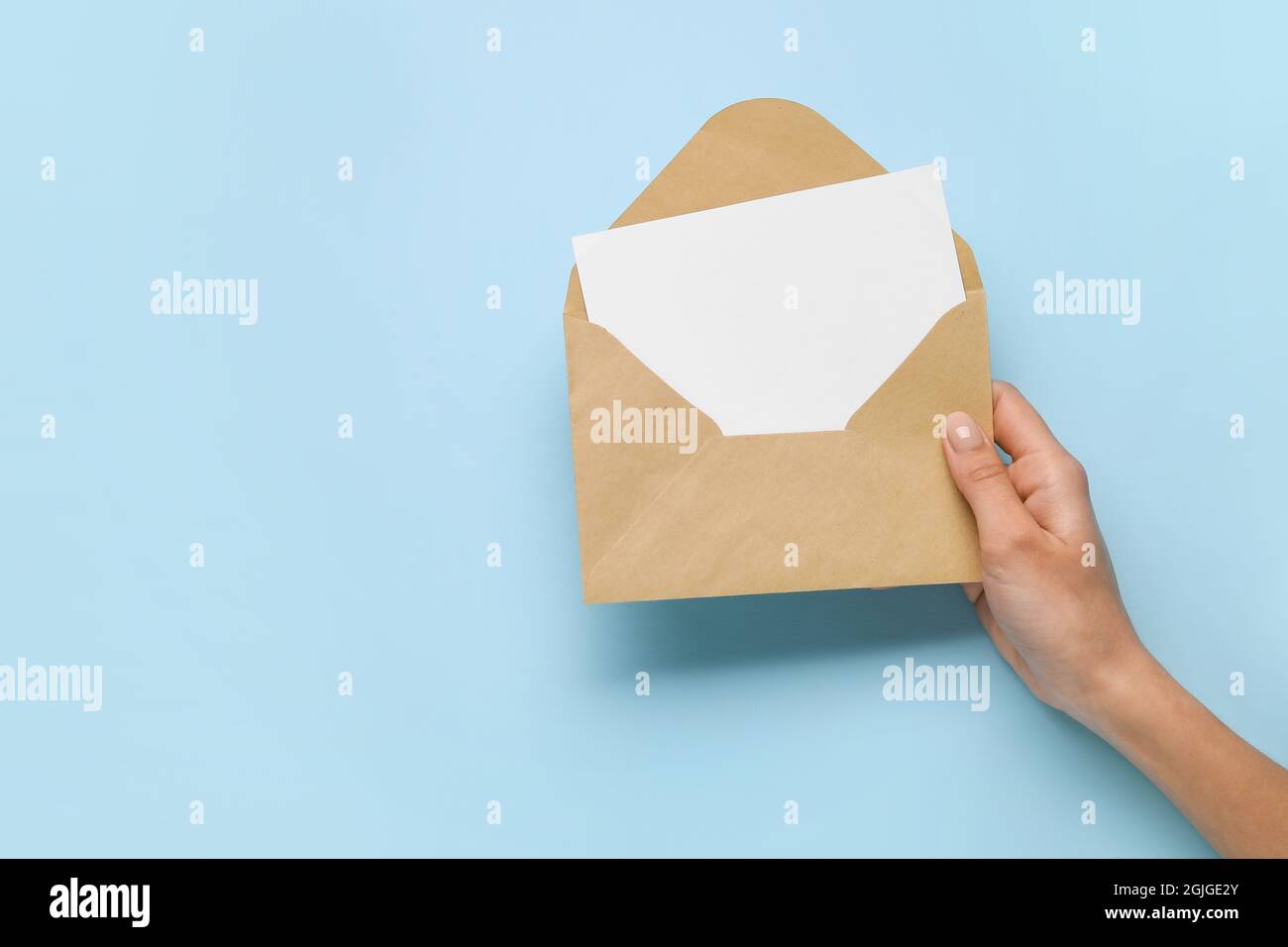 Female hand with envelope and blank card on color background Stock ...