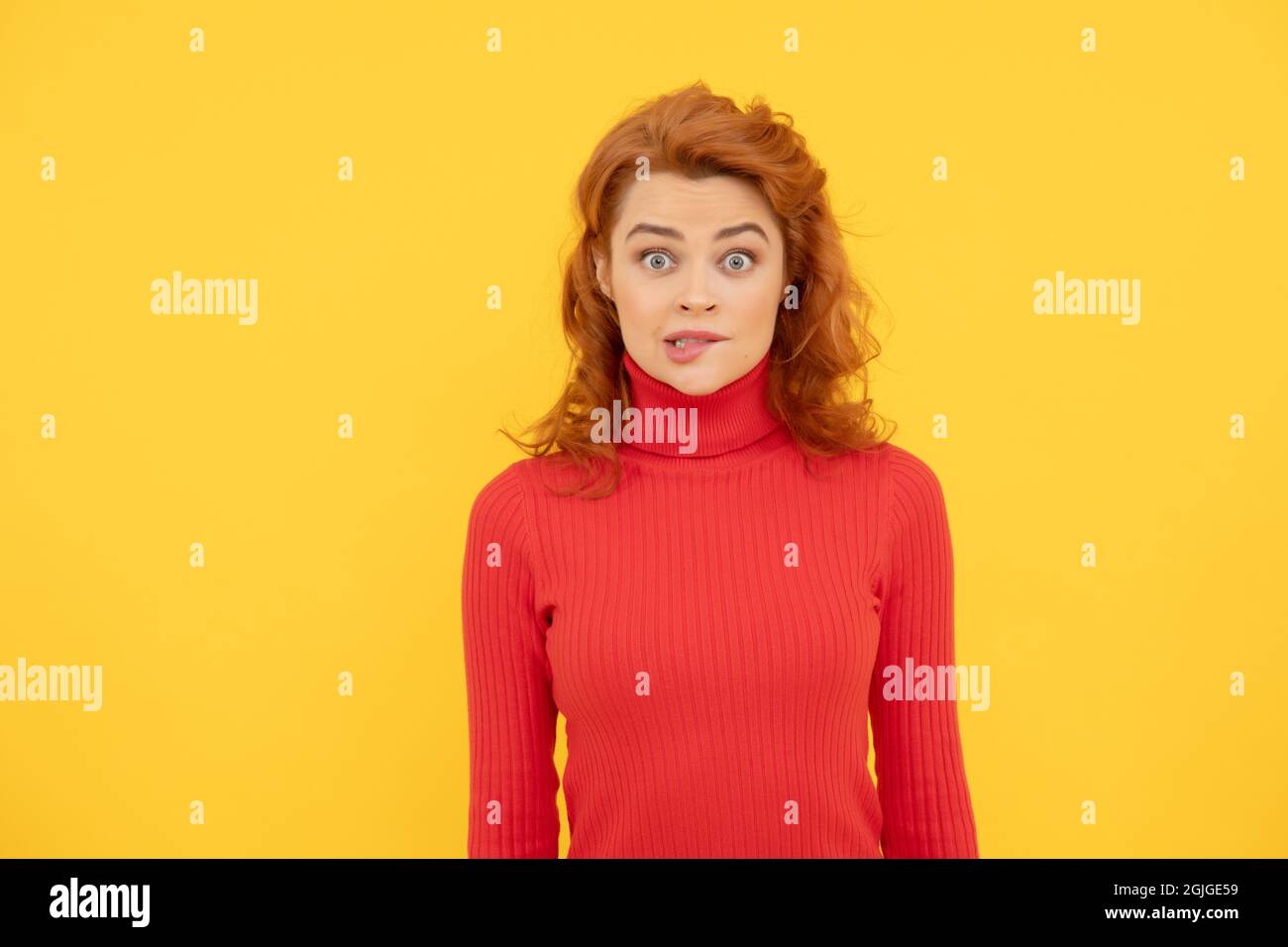 shocked red haired woman. surprised redhead woman on yellow background ...