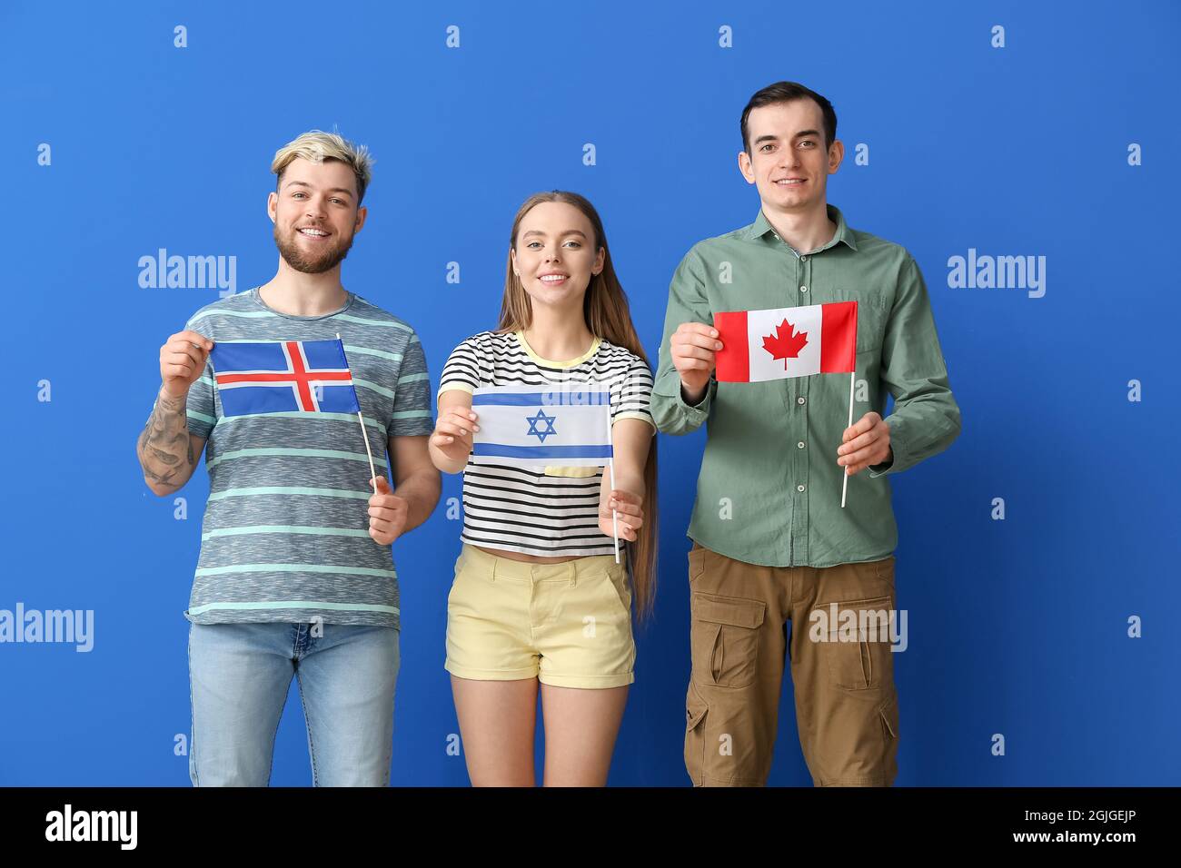 Young people with different flags on color background Stock Photo - Alamy