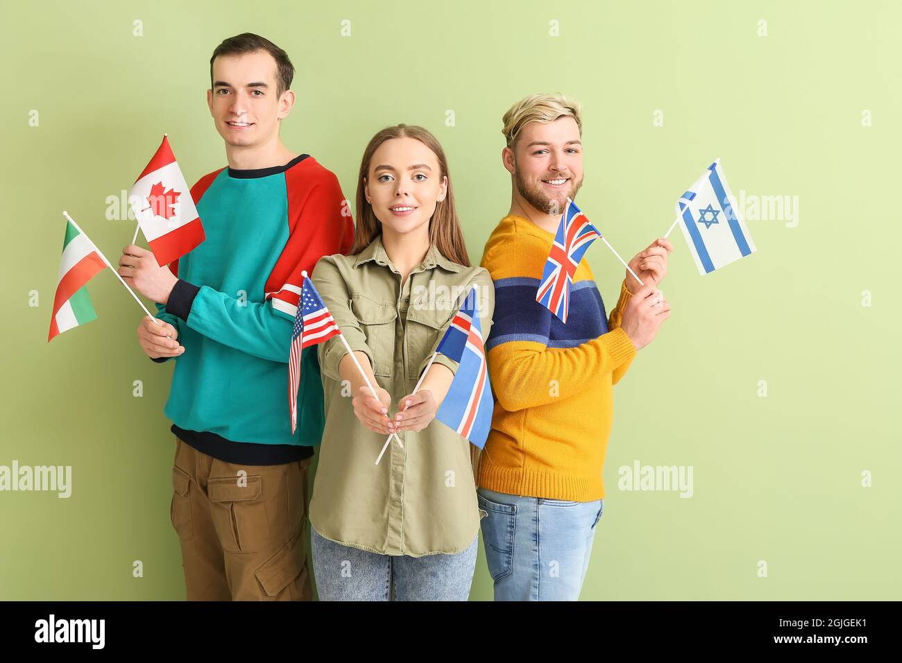 Young people with different flags on color background Stock Photo - Alamy