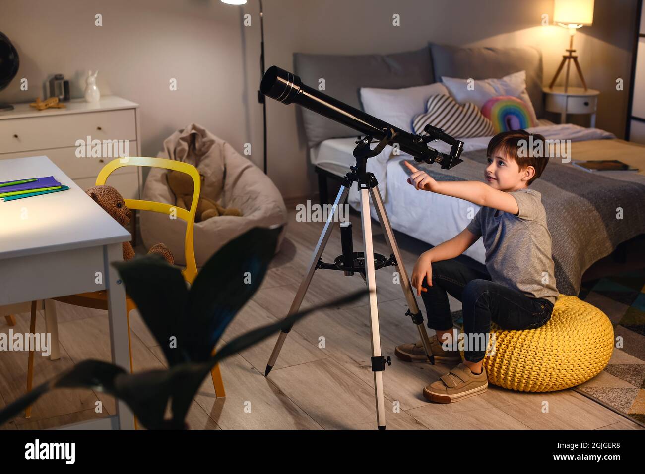 Little boy looking at stars through telescope in evening Stock Photo ...