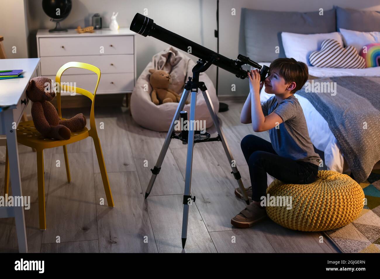 Little boy looking at stars through telescope in evening Stock Photo ...