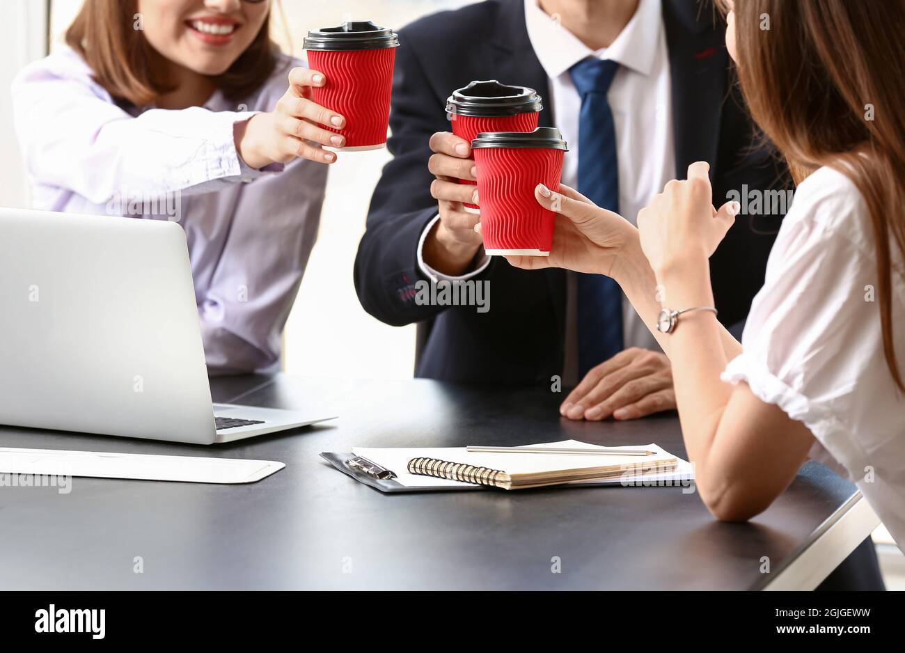 Business colleagues drinking coffee in office Stock Photo - Alamy