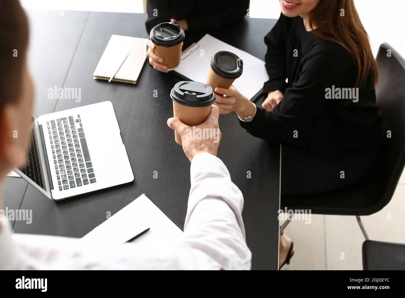 Business colleagues drinking coffee in office Stock Photo - Alamy