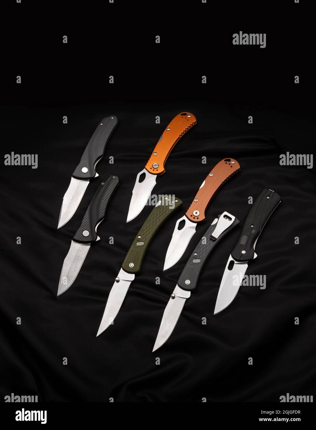 Various folding pocket knives on a dark background. A versatile pocket ...