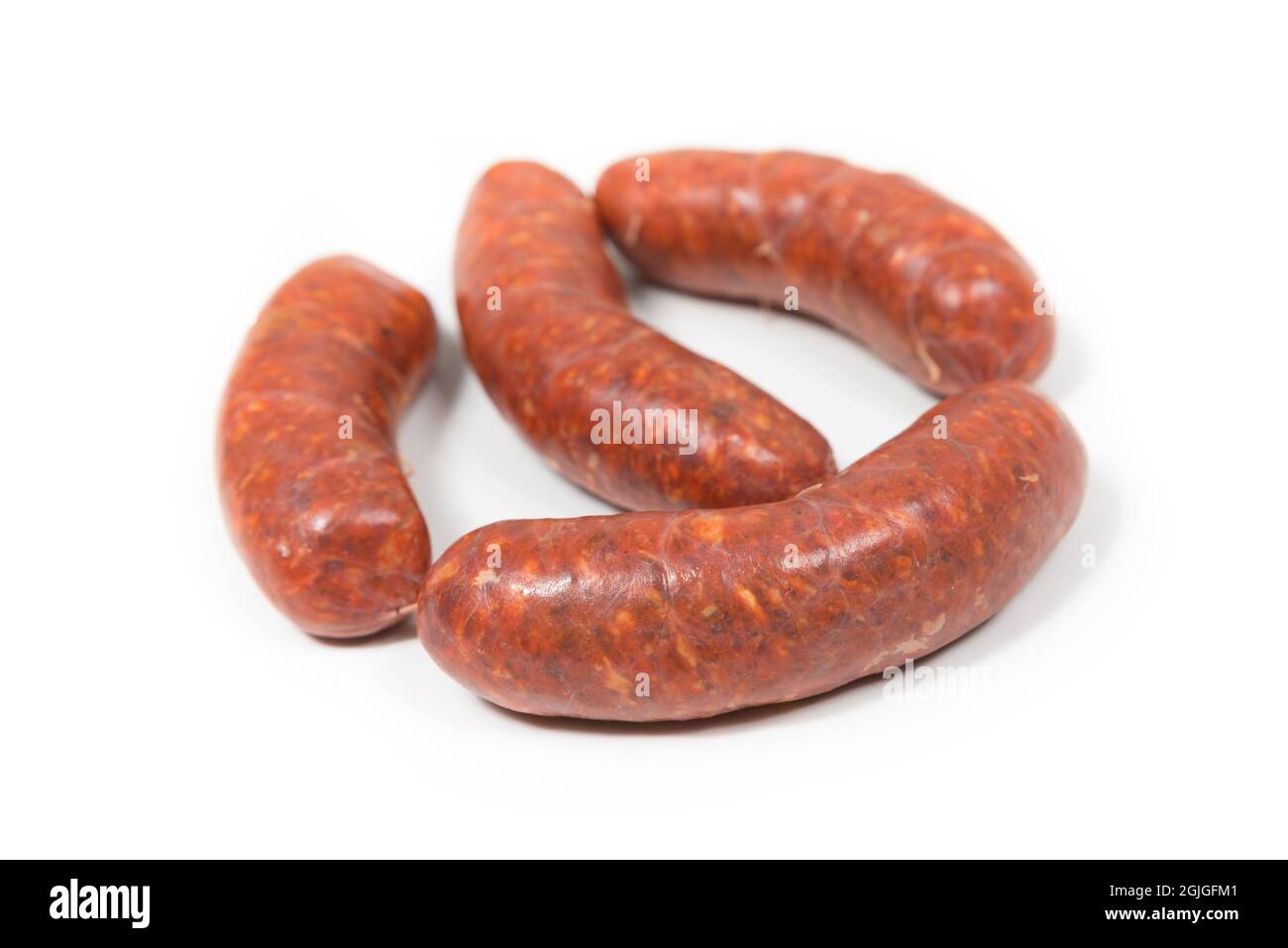 Four crude chorizo red sausages on a white background Stock Photo - Alamy