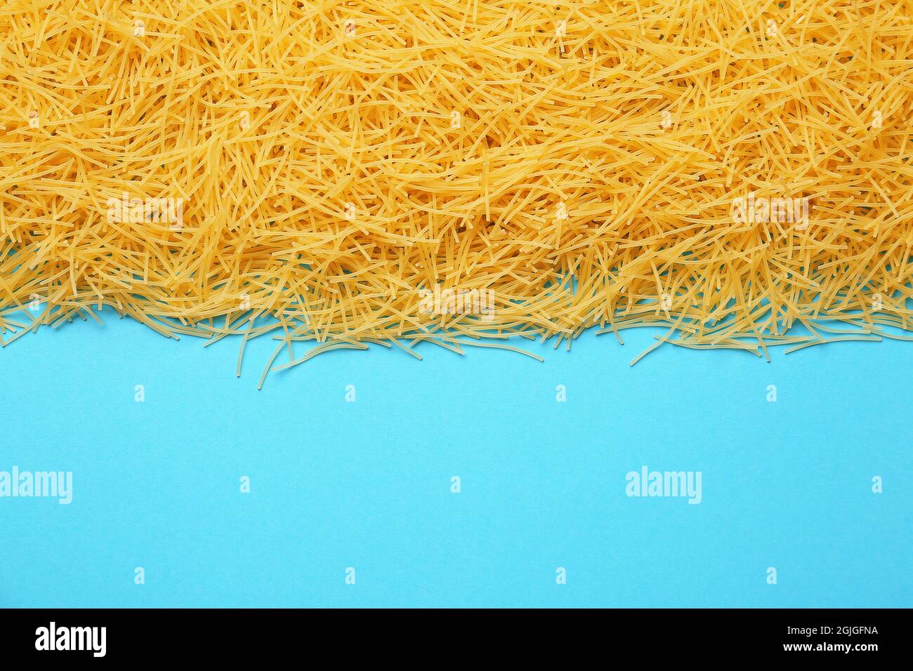 Uncooked vermicelli pasta on color background Stock Photo - Alamy
