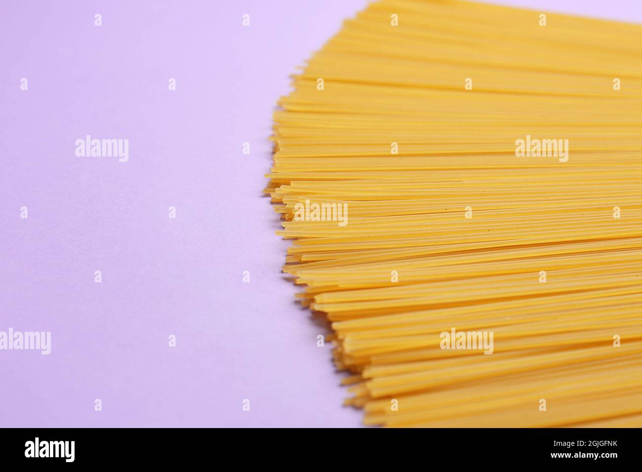 Uncooked spaghetti pasta on color background Stock Photo - Alamy