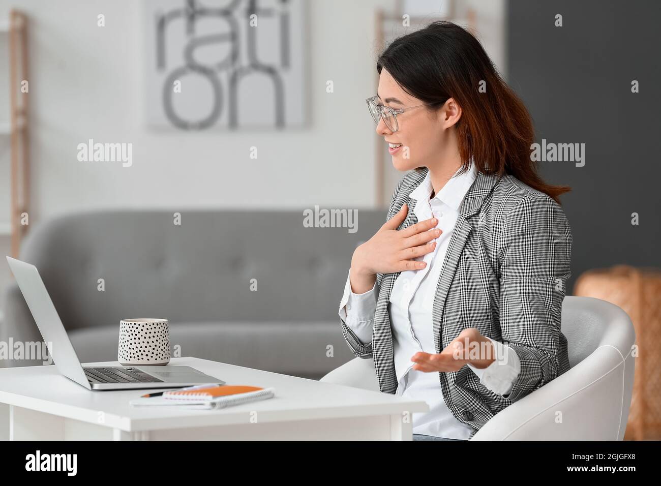 Young woman having interview online at home Stock Photo - Alamy
