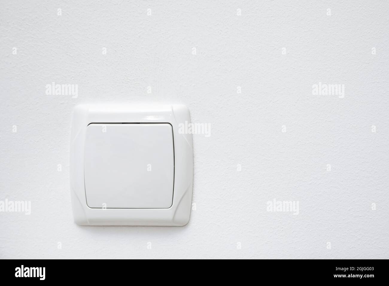Modern light switch on white wall Stock Photo - Alamy