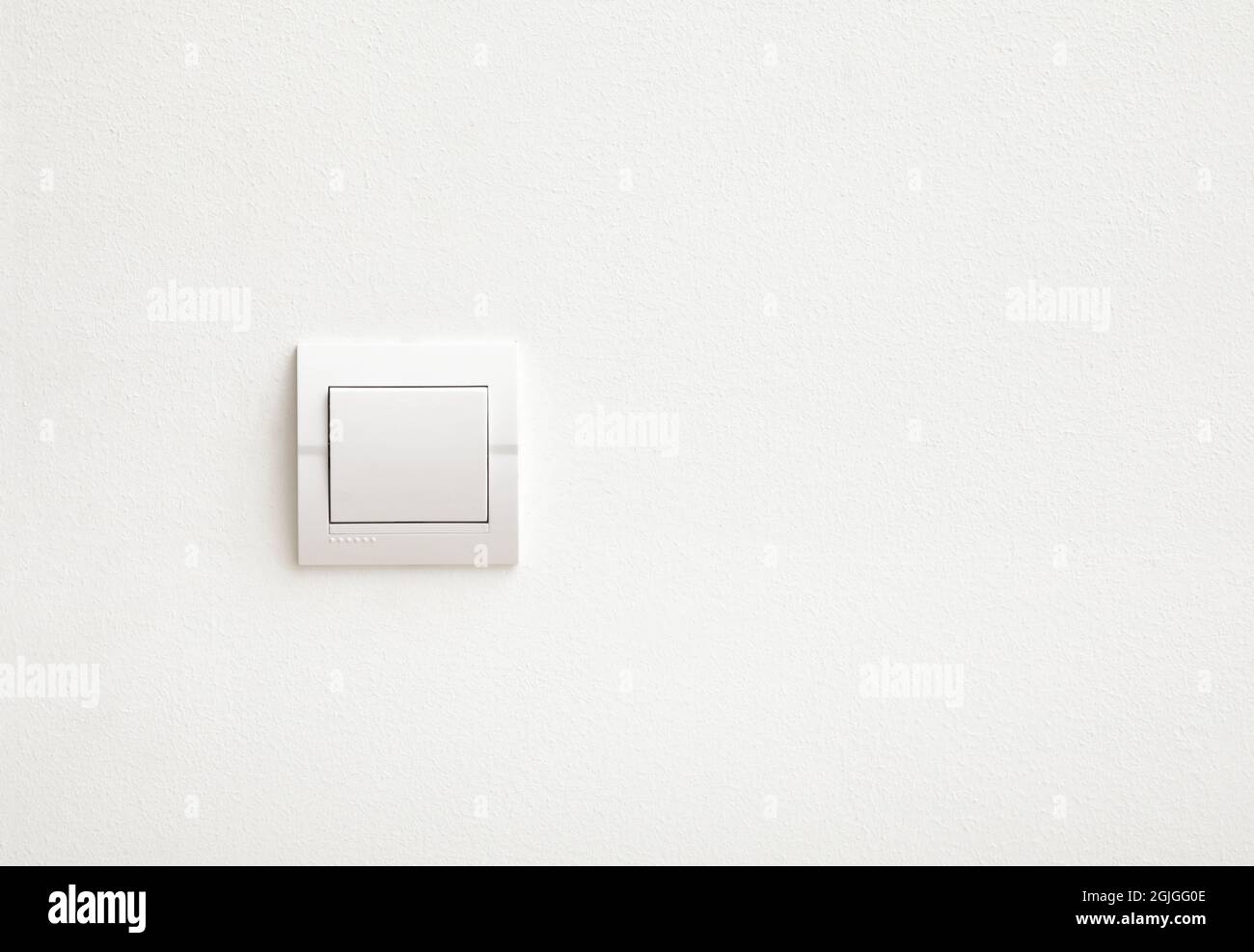 Modern light switch on white wall Stock Photo - Alamy