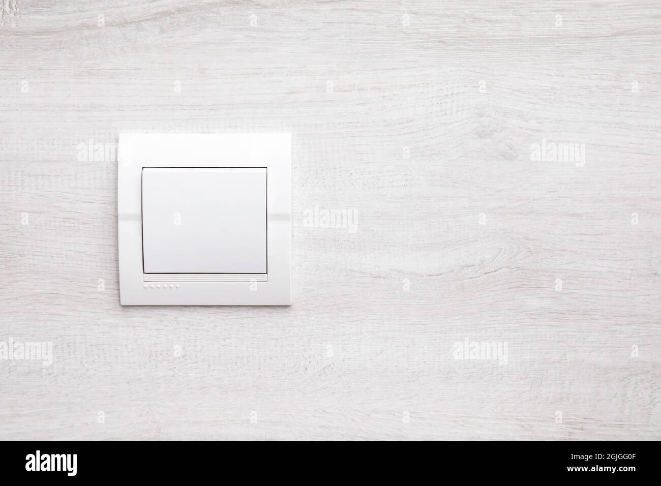 Modern light switch on white wall Stock Photo - Alamy