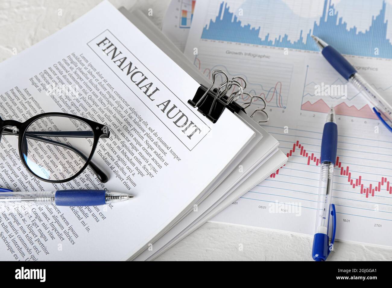 Financial audit documents, glasses and pen on table Stock Photo - Alamy