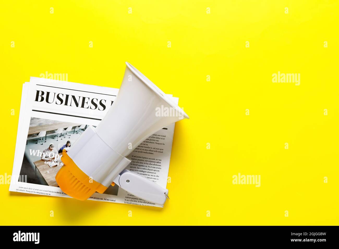 Modern megaphone and newspaper on color background Stock Photo - Alamy