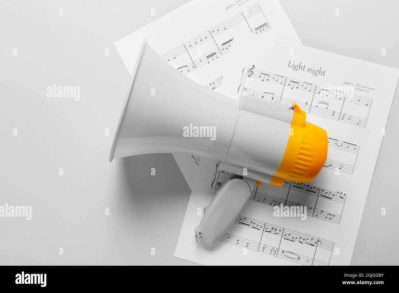 Modern megaphone and music notes on light background Stock Photo - Alamy