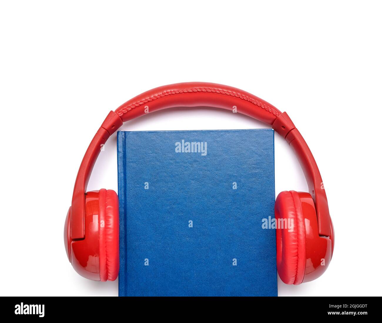Modern headphones with book on white background Stock Photo - Alamy