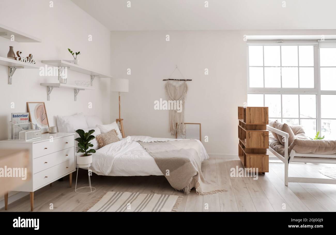 Interior of stylish room with comfortable bed Stock Photo - Alamy