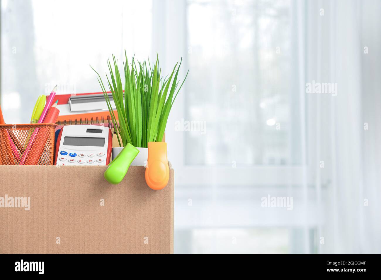 Box with personal stuff near window Stock Photo - Alamy