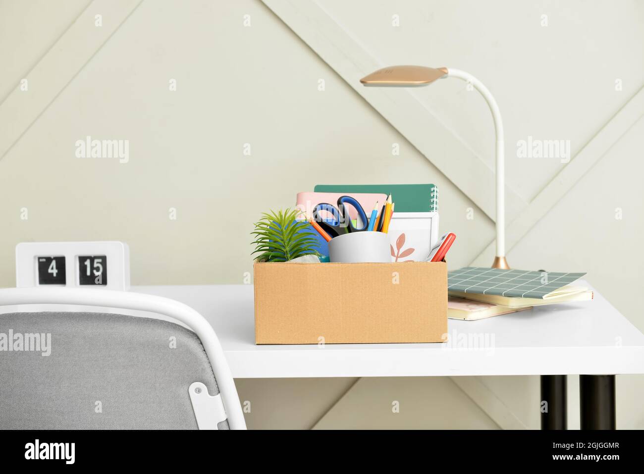 Box with personal stuff on table in office Stock Photo - Alamy