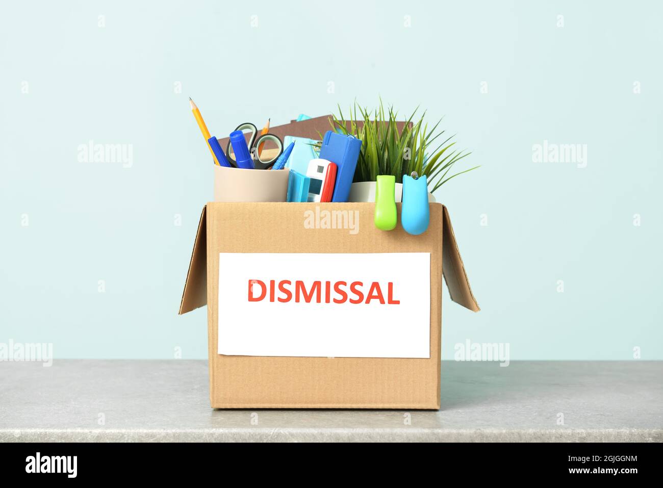 Box with personal stuff on table near color wall Stock Photo - Alamy