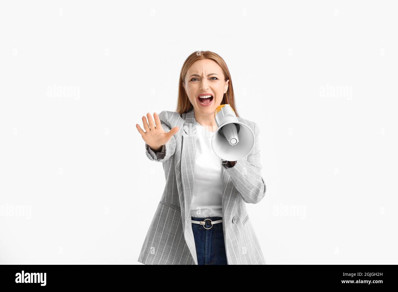 Angry mature woman shouting into megaphone on white background Stock ...