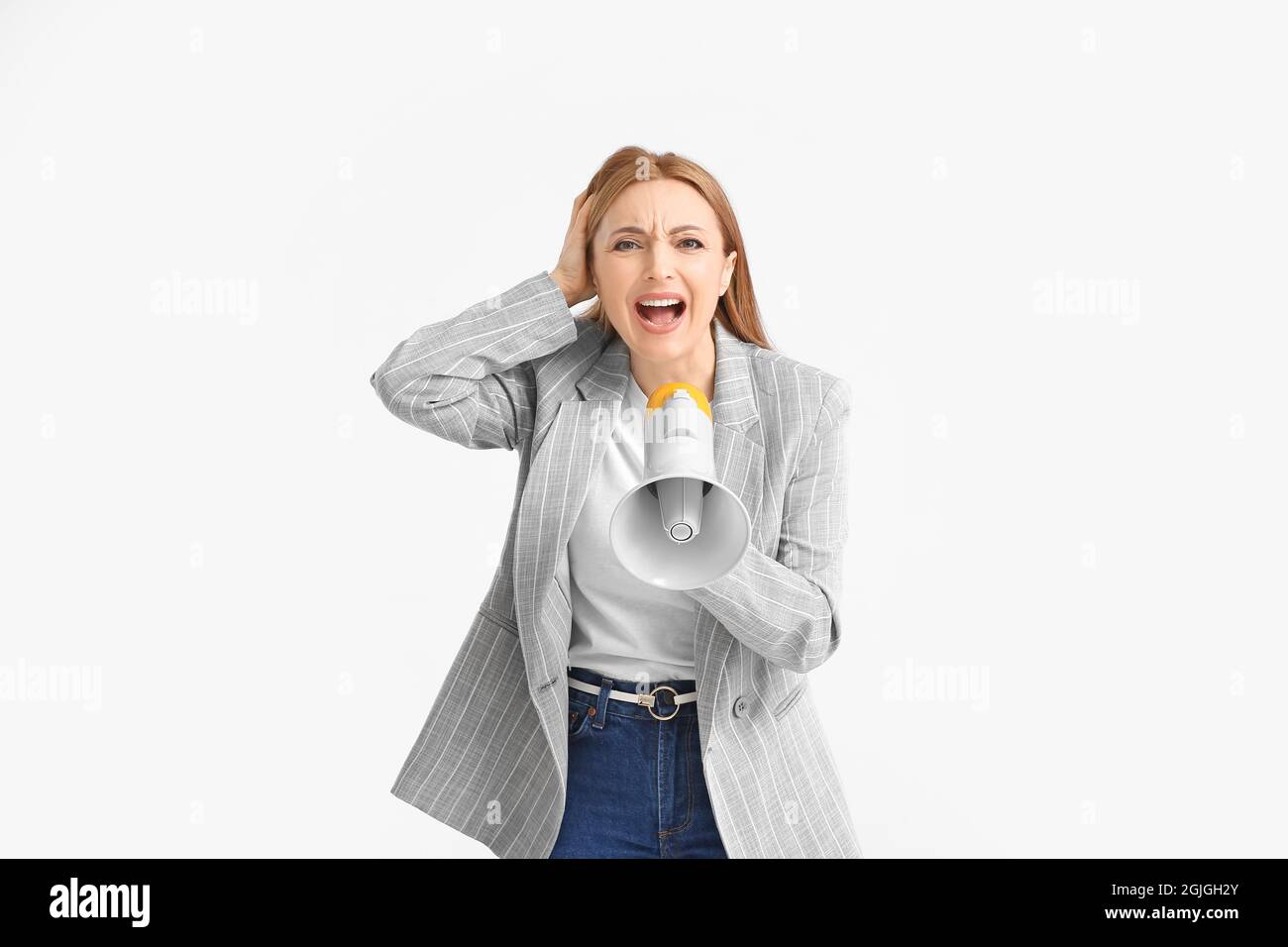 Angry mature woman shouting into megaphone on white background Stock ...