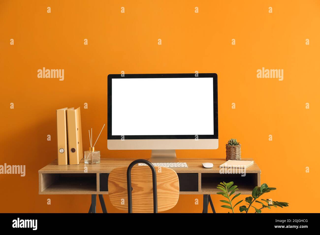 Modern workplace with computer near color wall Stock Photo - Alamy