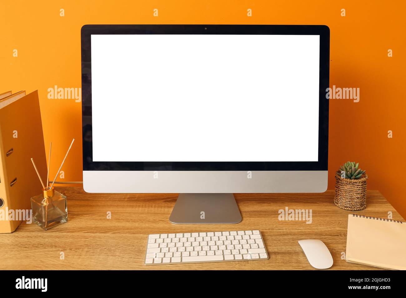 Modern workplace with computer near color wall Stock Photo - Alamy