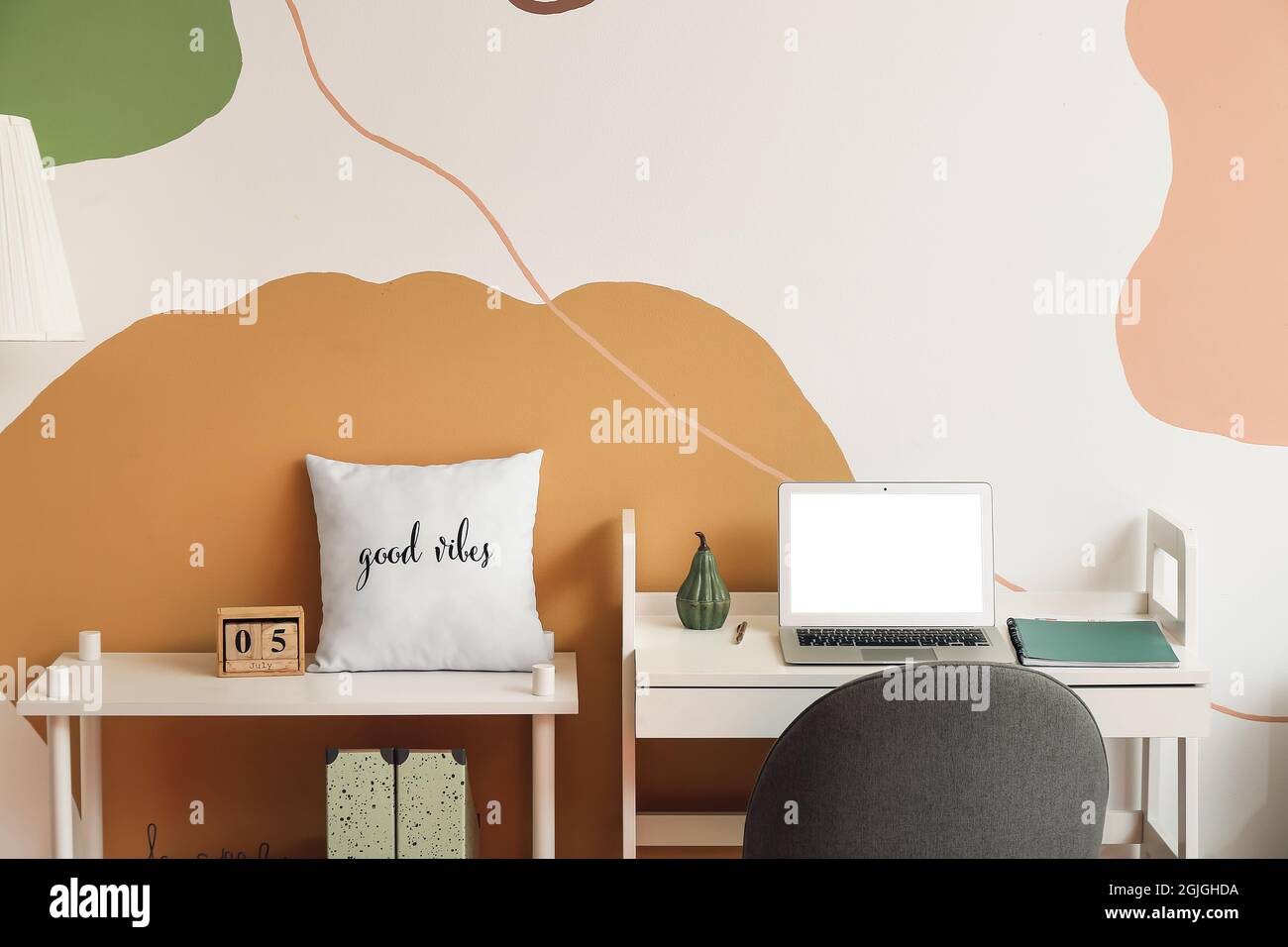 Modern workplace with laptop near color wall Stock Photo - Alamy