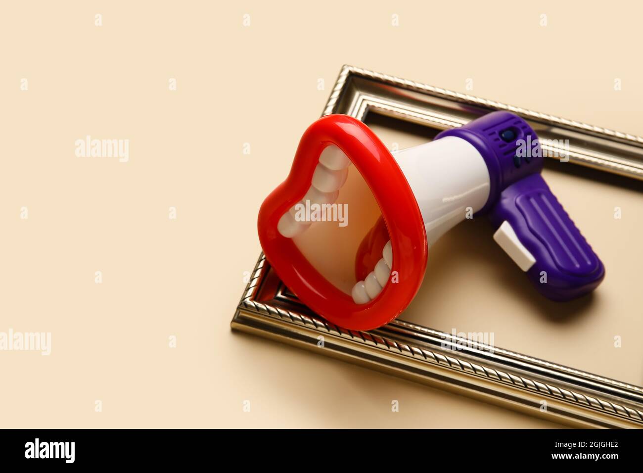 Toy megaphone with frame on color background Stock Photo - Alamy