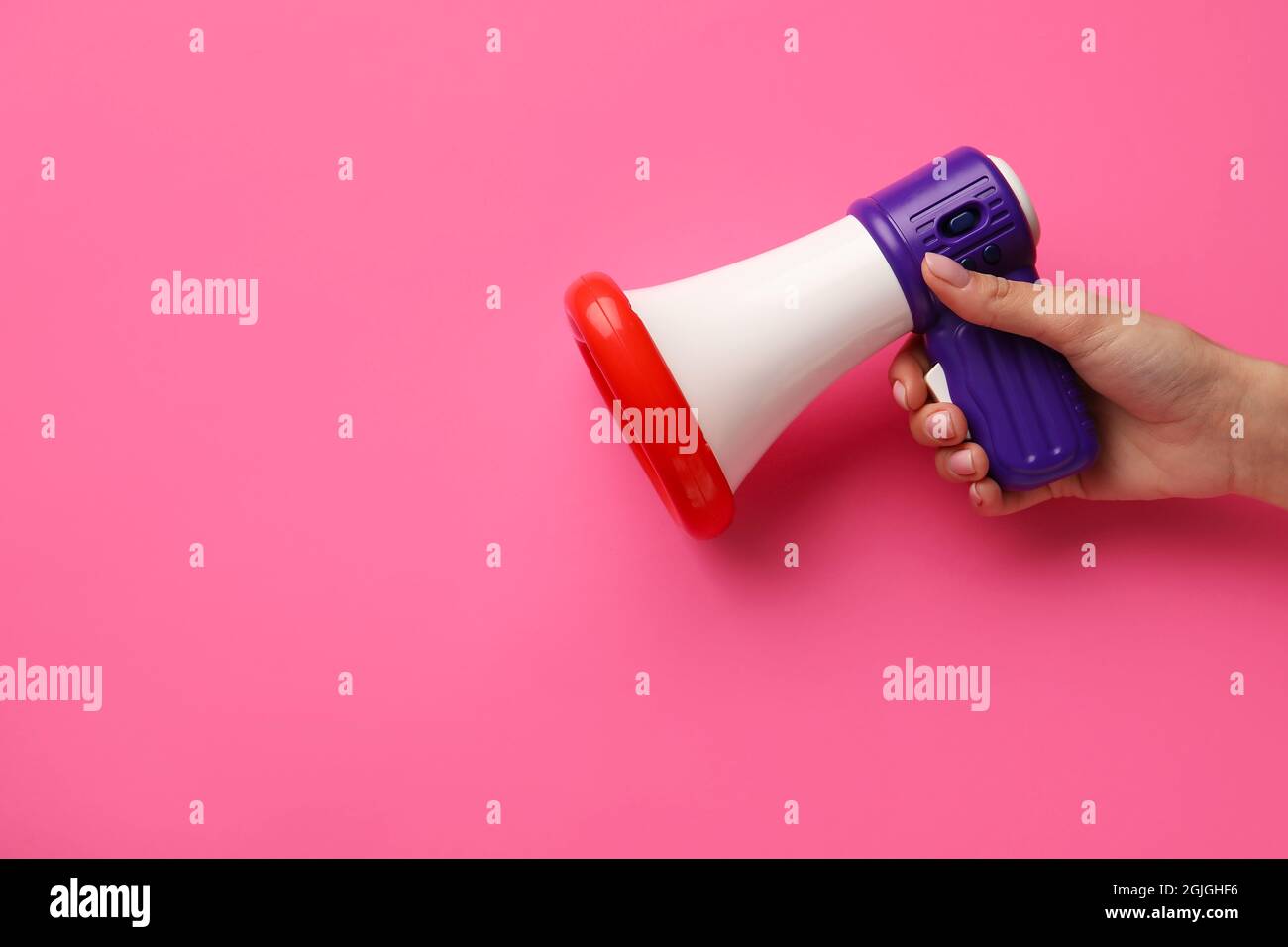 Woman with toy megaphone on color background Stock Photo - Alamy