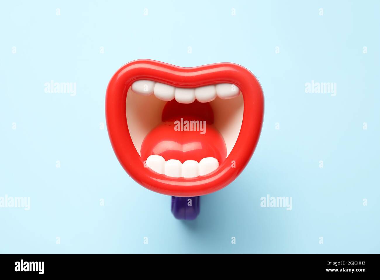 Toy megaphone on blue background Stock Photo - Alamy