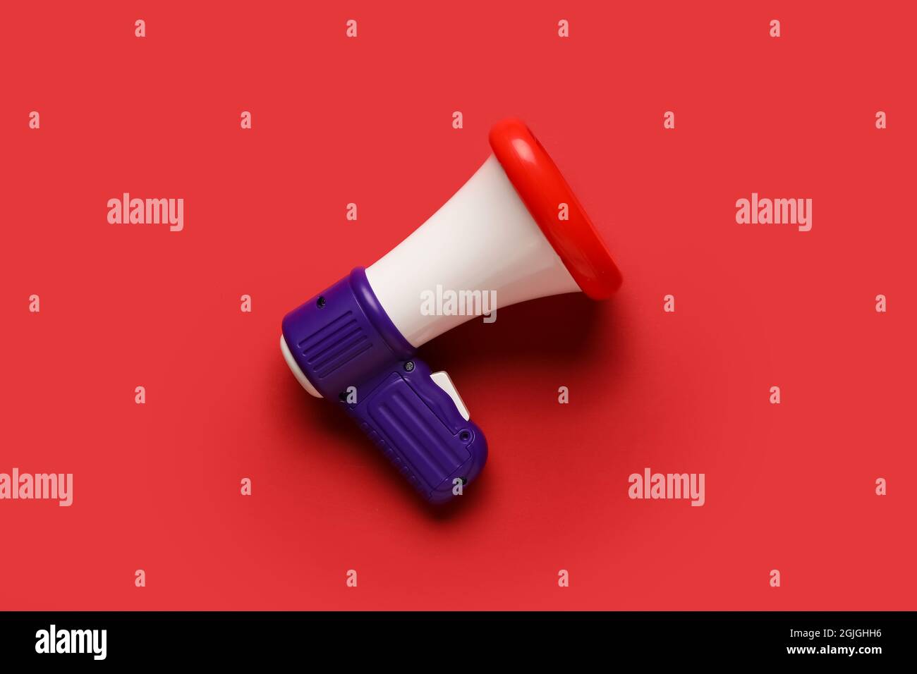 Toy megaphone on red background Stock Photo - Alamy