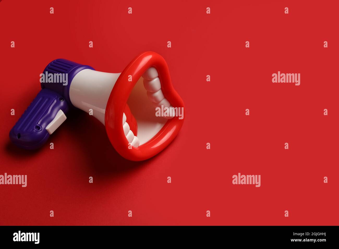 Toy megaphone on red background Stock Photo - Alamy