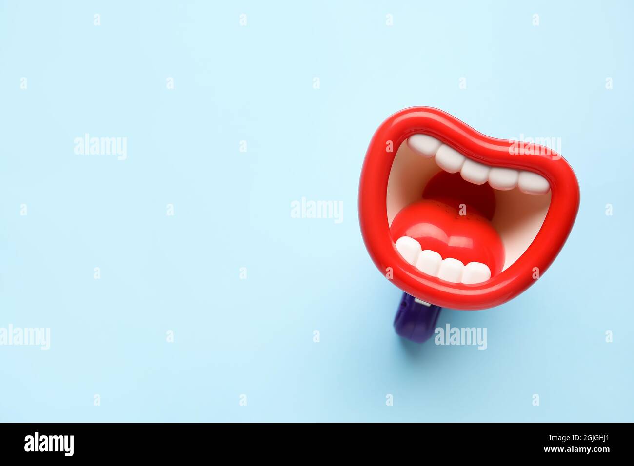 Toy megaphone on blue background Stock Photo - Alamy