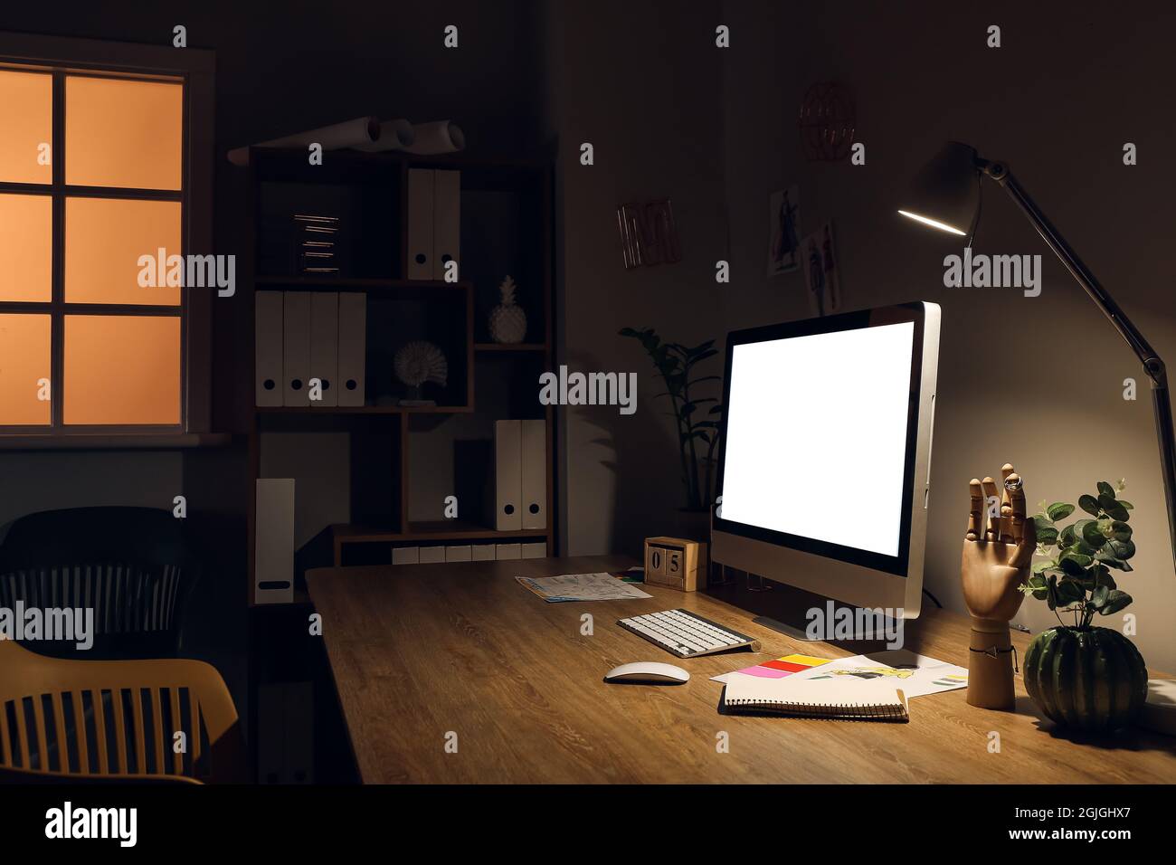 Modern workplace with computer in dark room Stock Photo - Alamy