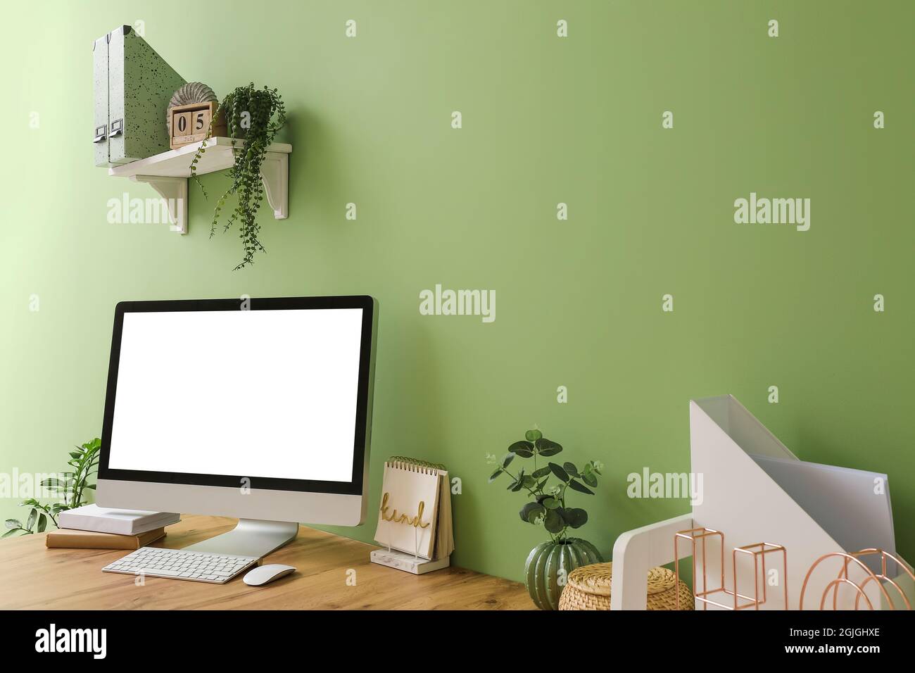 Modern workplace with computer near color wall Stock Photo - Alamy
