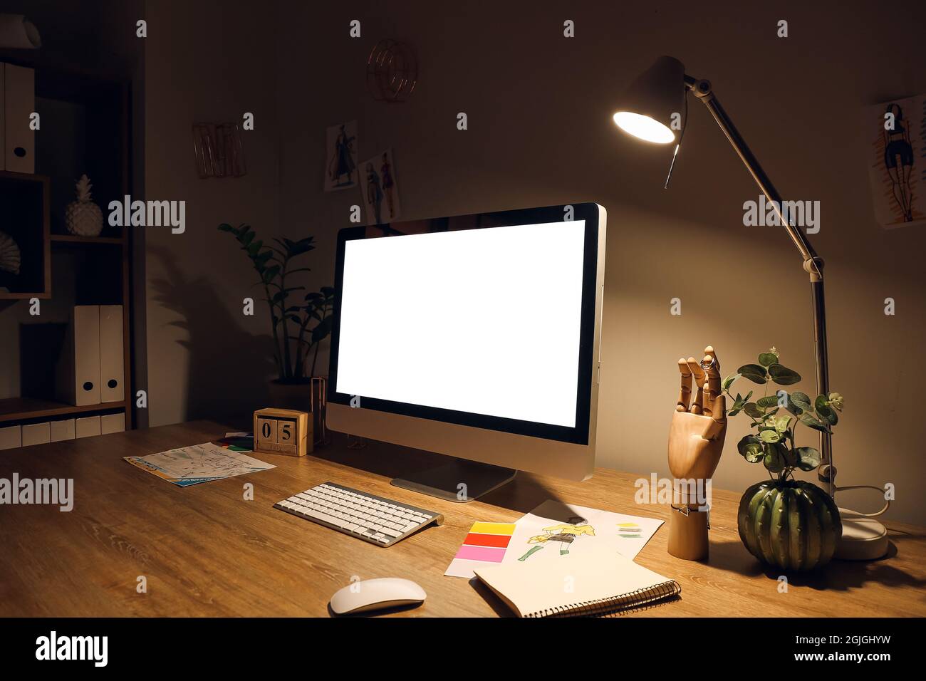 Modern workplace with computer in dark room Stock Photo - Alamy