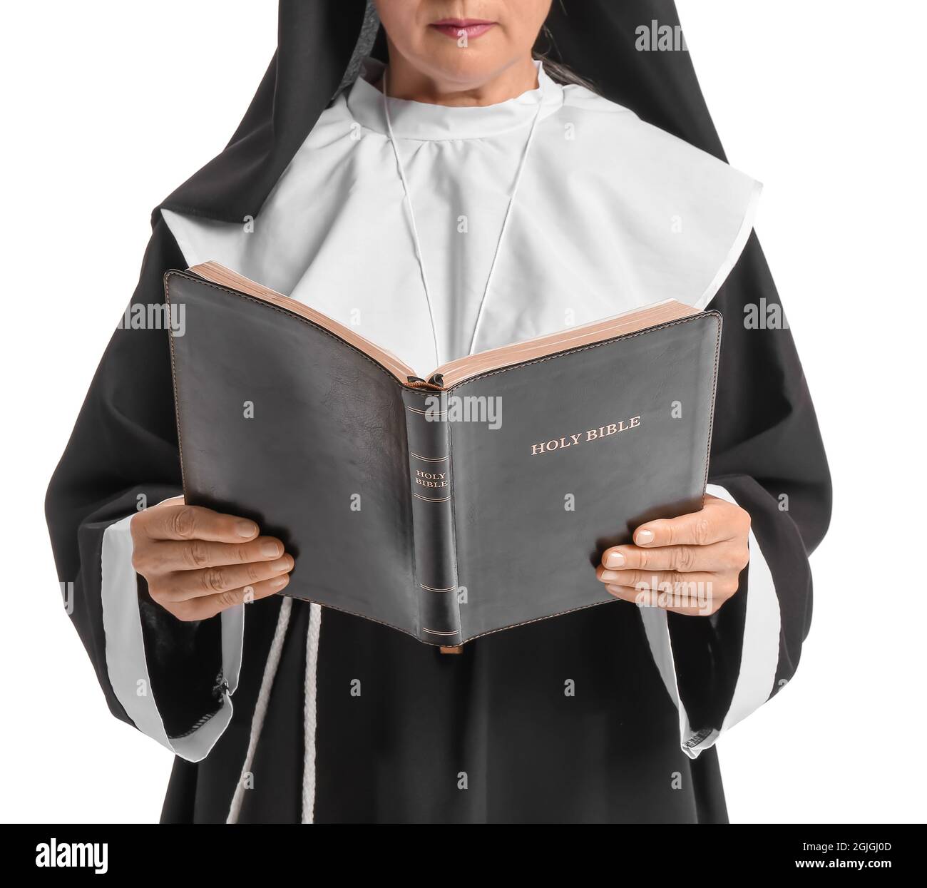 Mature nun reading Holy Bible on white background Stock Photo - Alamy