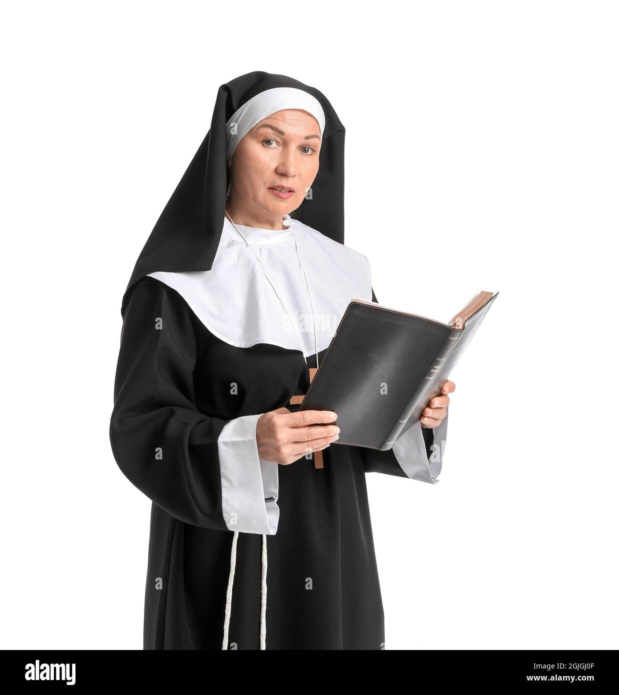 Mature nun reading Holy Bible on white background Stock Photo - Alamy